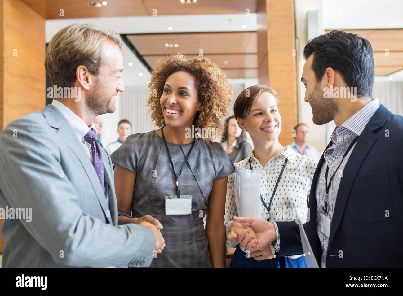 Four business people shaking hands at beginning of meeting Stock Photo ...
