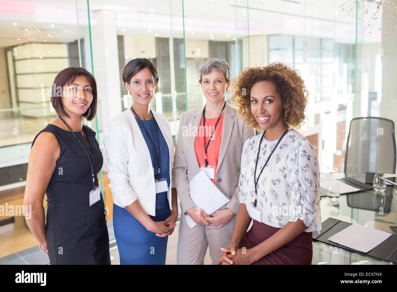 Portrait of four women standing in conference room Stock Photo - Alamy