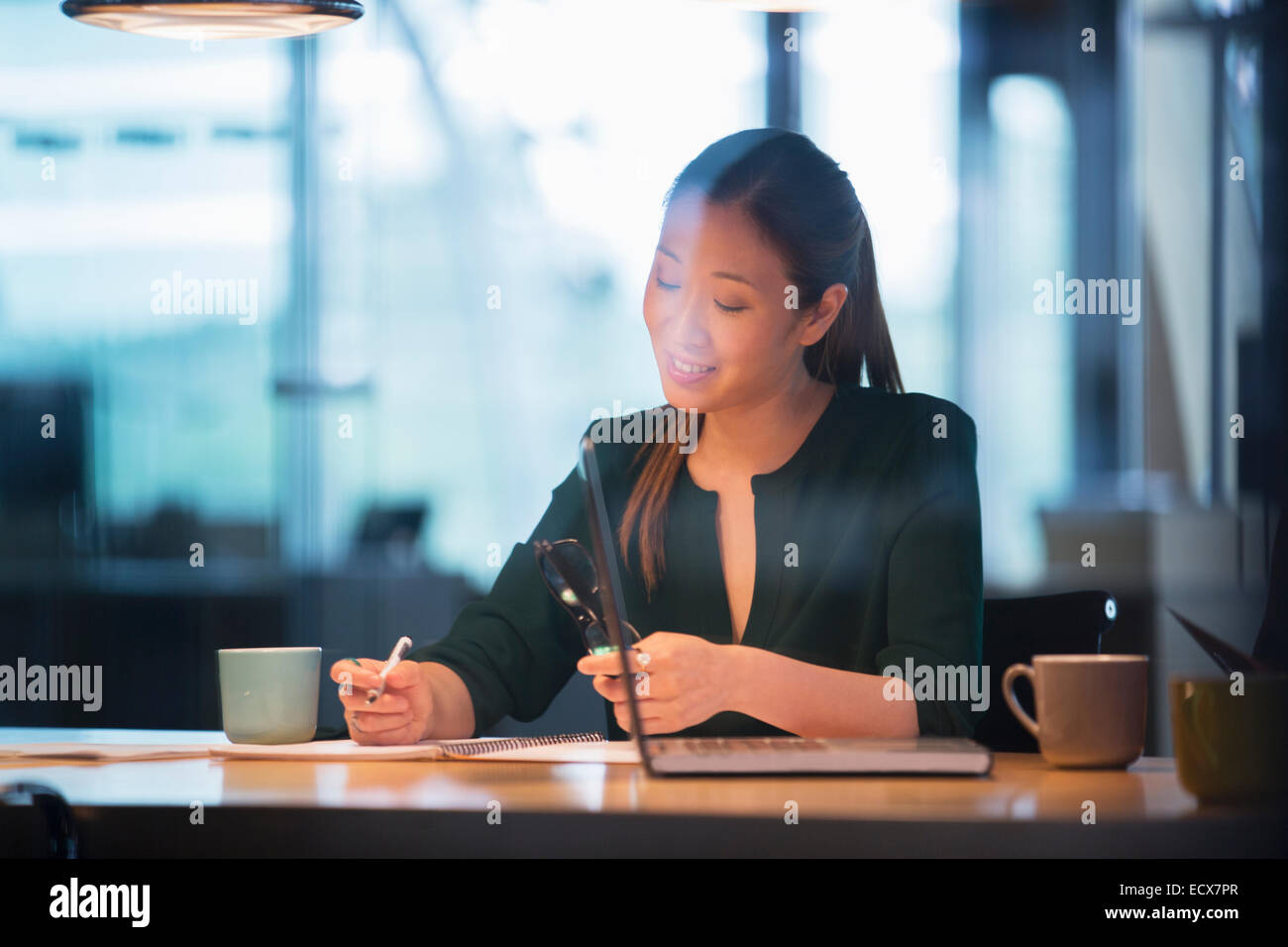 Businesswoman writing in office Stock Photo - Alamy Businesswoman writing in office Stock Photo - Alamy