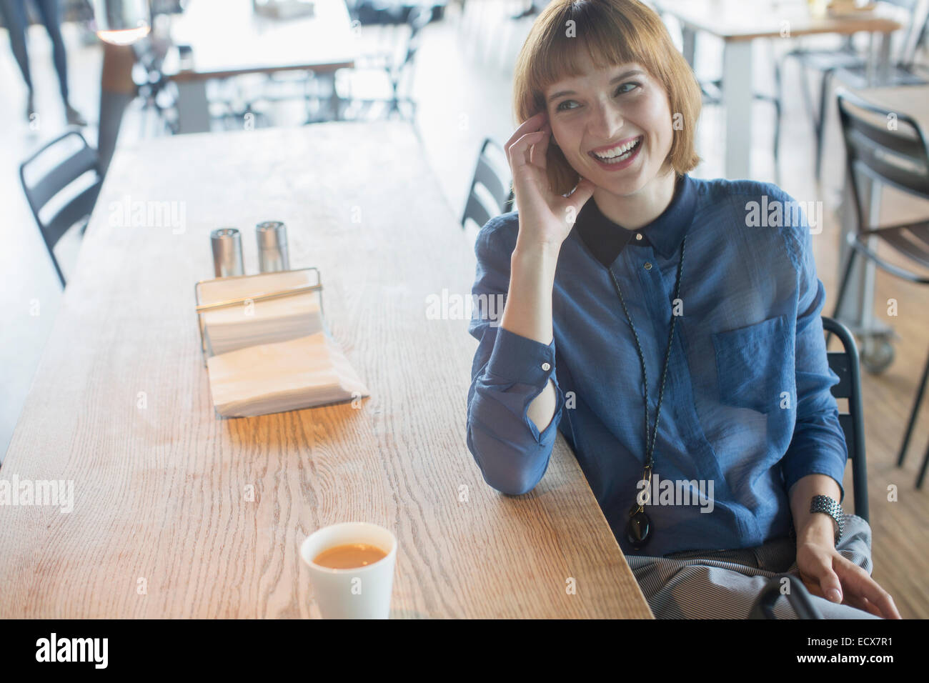 Businesswoman laughing at cafeteria table Stock Photo - Alamy