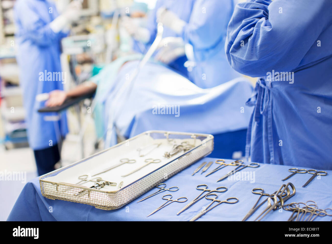 Nurse standing by tray with surgical tools in operating theater Stock ...