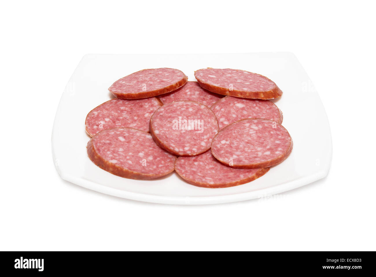 Sliced sausage with plate isolated on white Stock Photo - Alamy