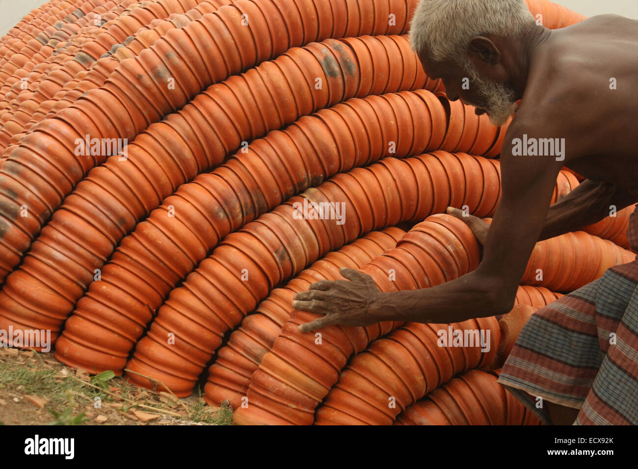 A mud pot seller store-keeping for sale at river bank of Rayer Bazar in ...