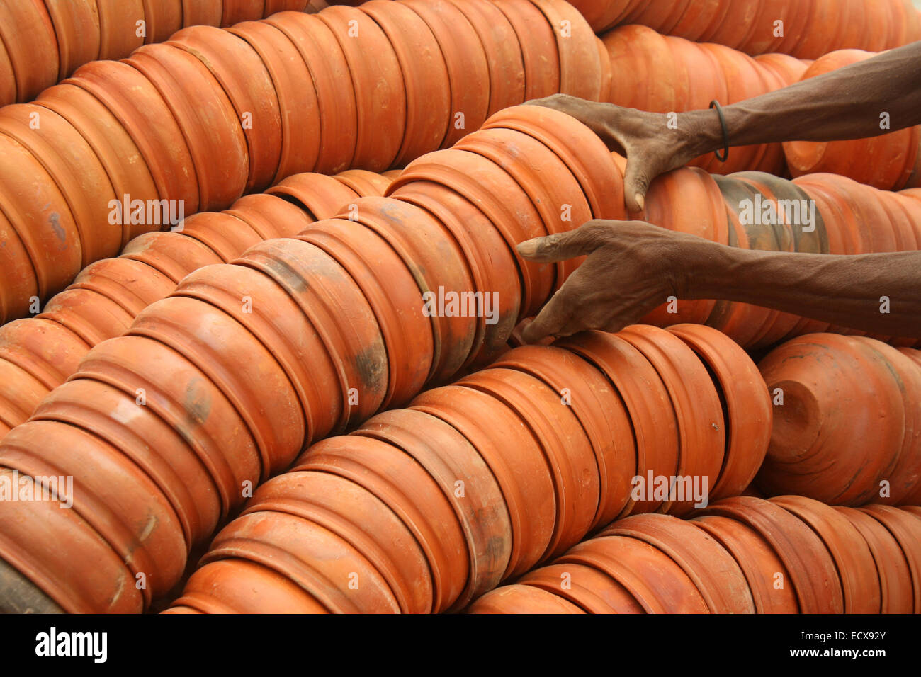 A mud pot seller store-keeping for sale at river bank of Rayer Bazar in ...