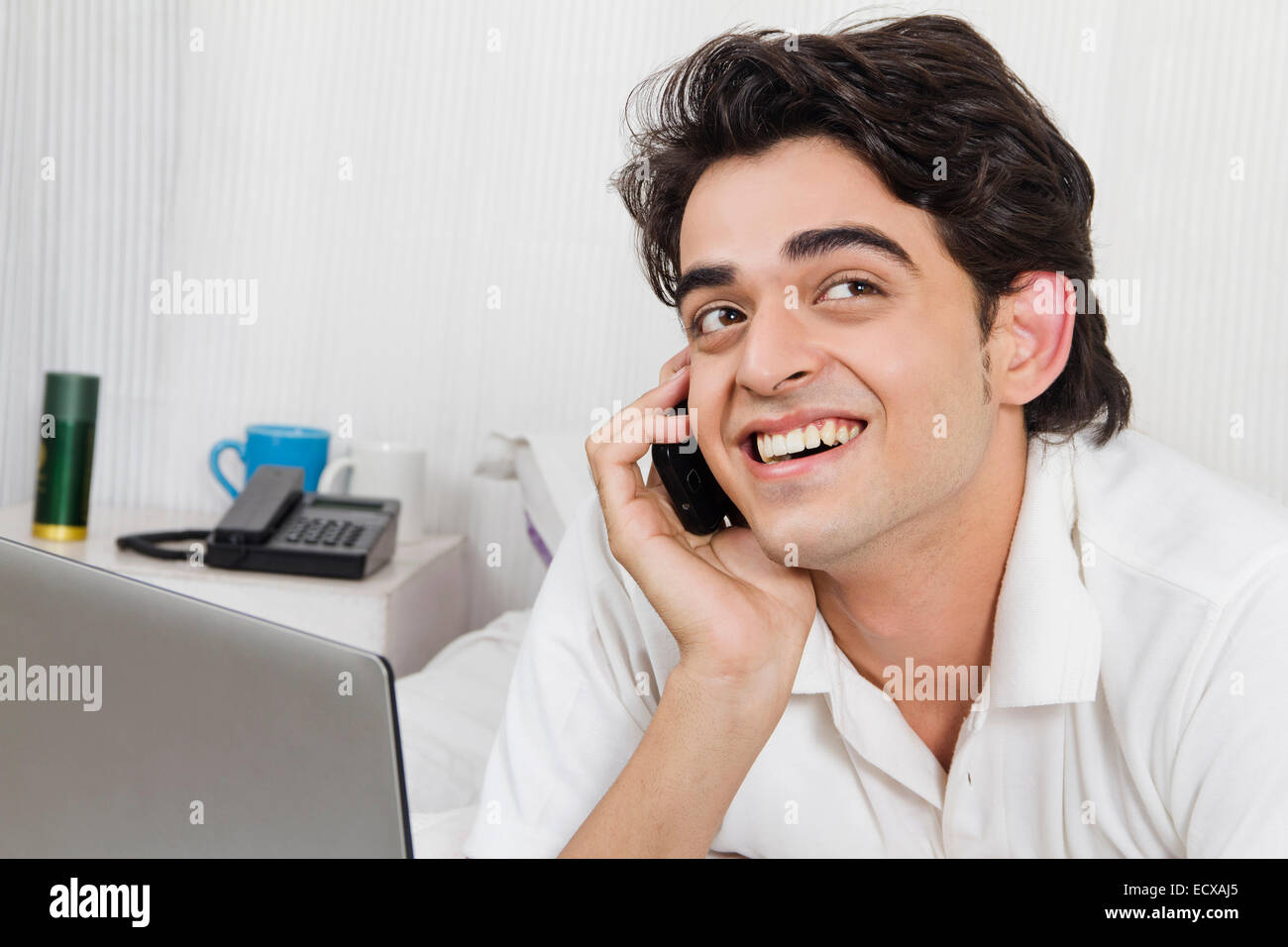 1 indian boy Laptop and talking phone Stock Photo - Alamy