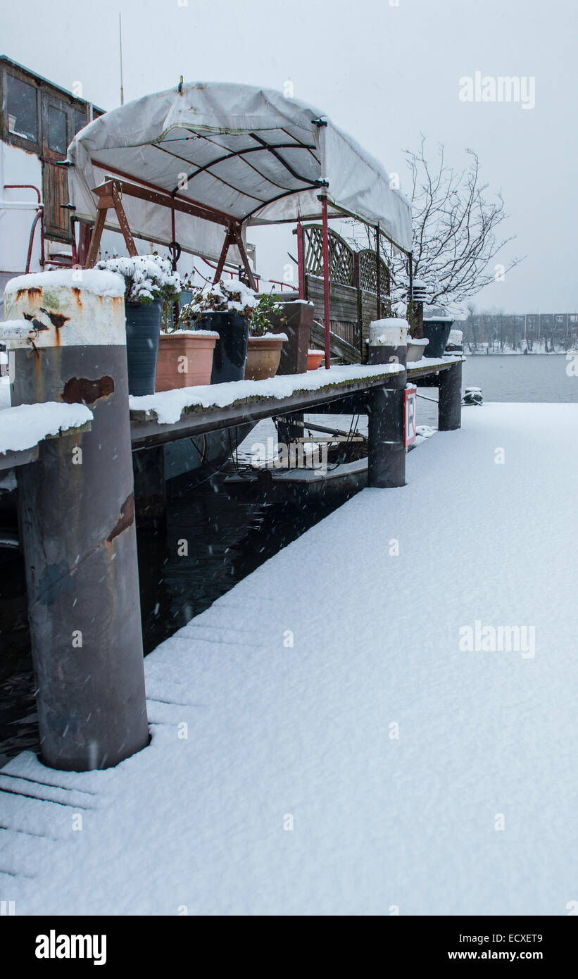 Snow covered two story pier with pot plants Stock Photo - Alamy