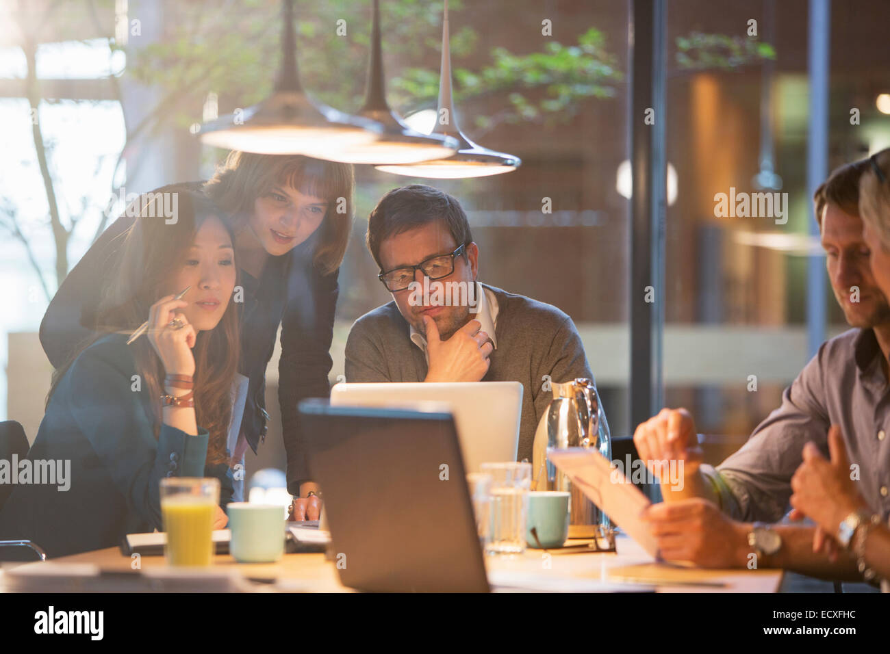 Business people using laptop in office meeting Stock Photo - Alamy