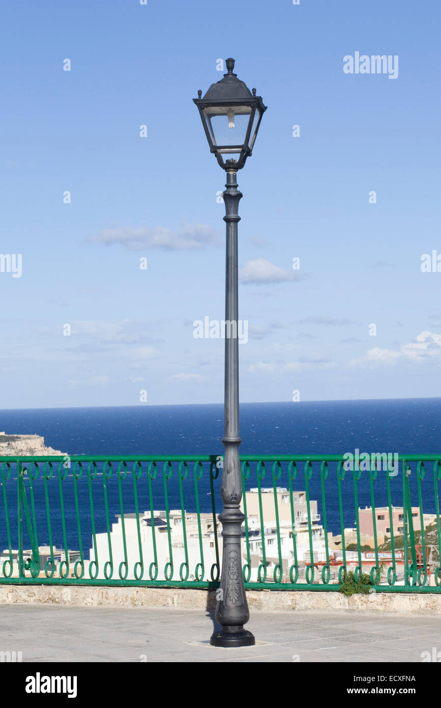 Street lamp on a pavement overlooking the ocean in Malta Stock Photo ...
