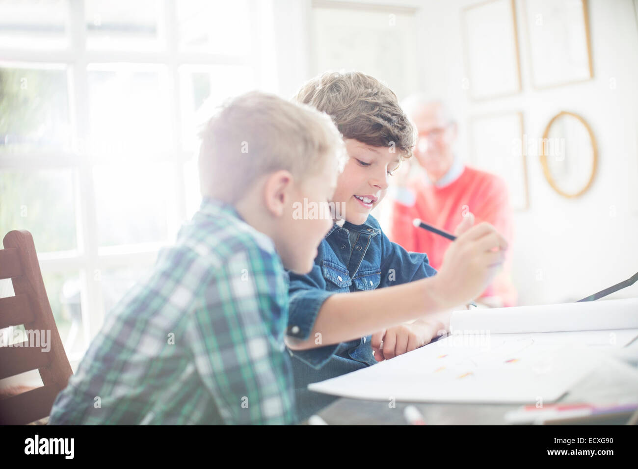 Children writing together hi-res stock photography and images - Alamy