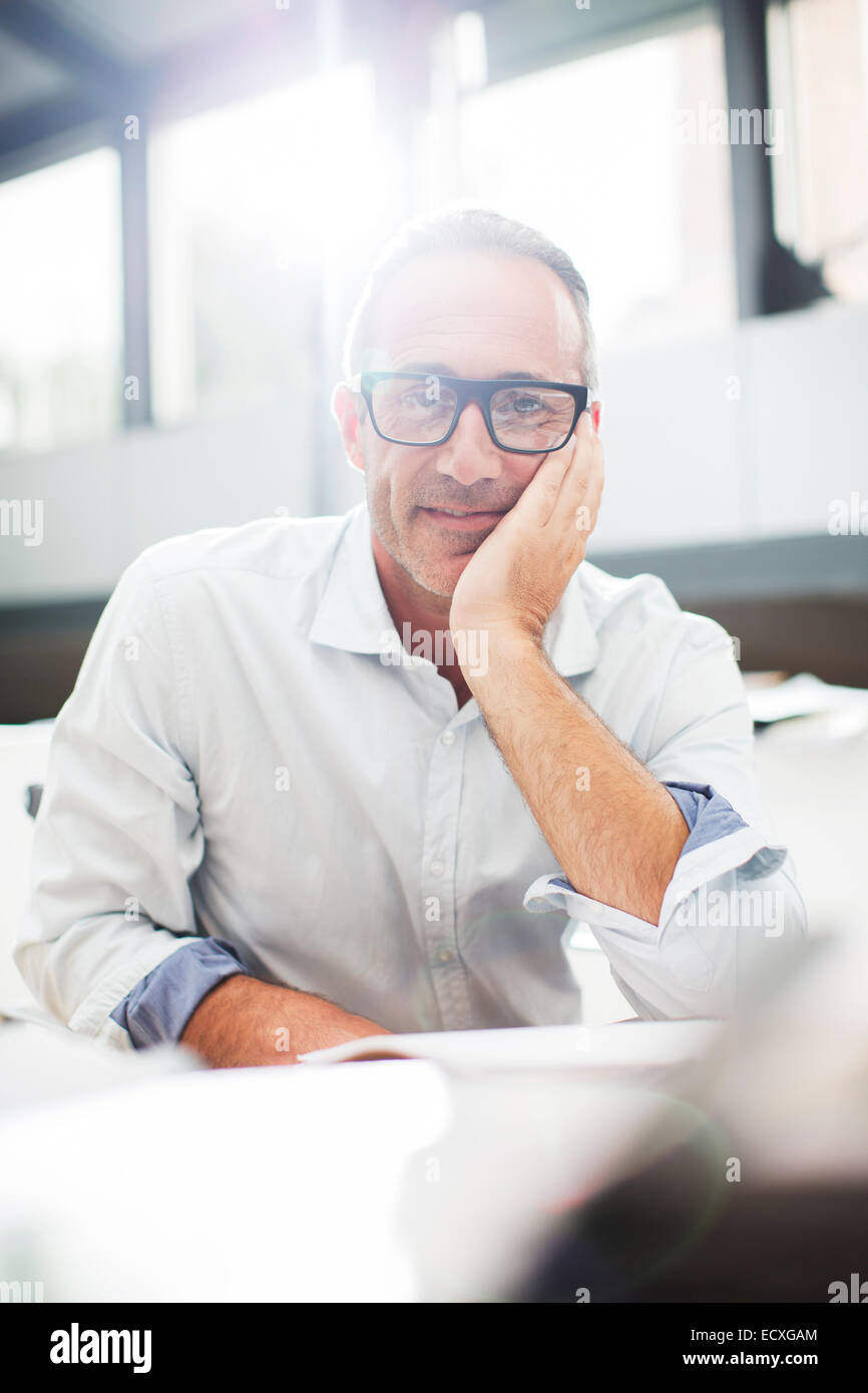 Man sitting at desk in front of computer Stock Photo - Alamy