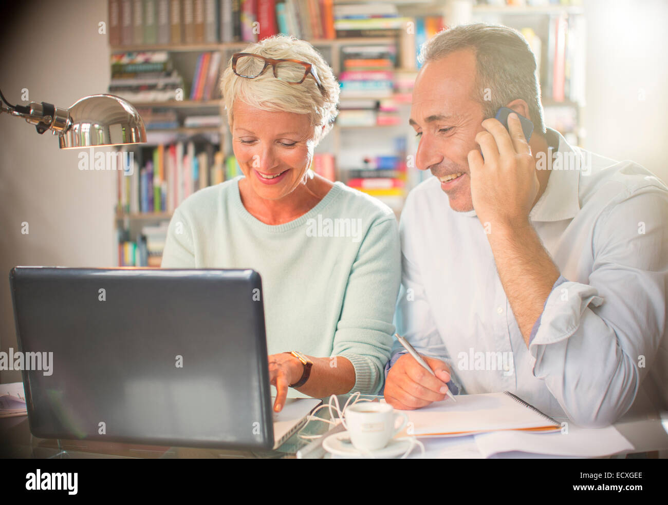Business people working together at home office desk Stock Photo - Alamy