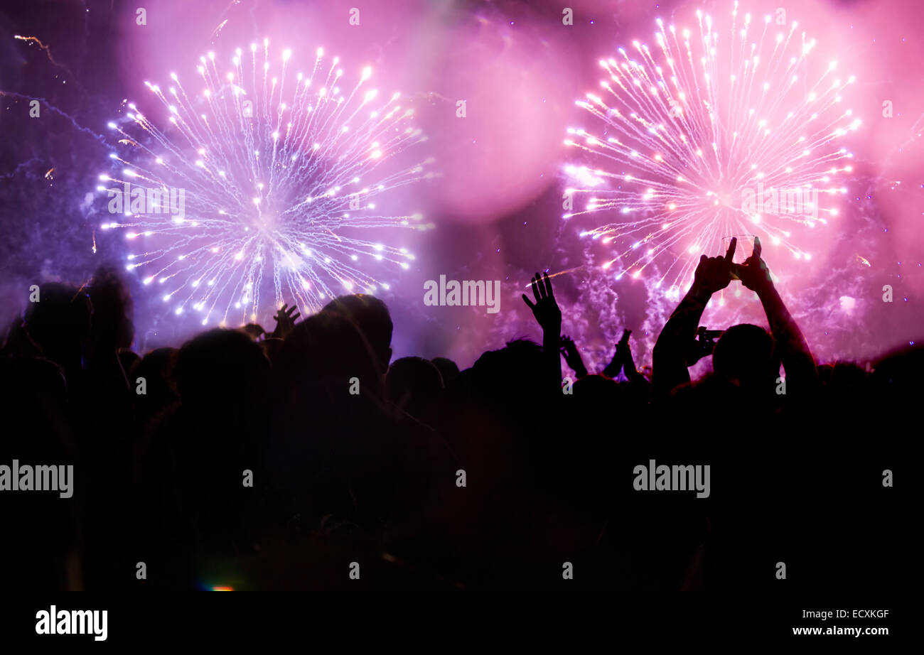 New Year concept - fireworks and cheering crowd celebrating the New ...