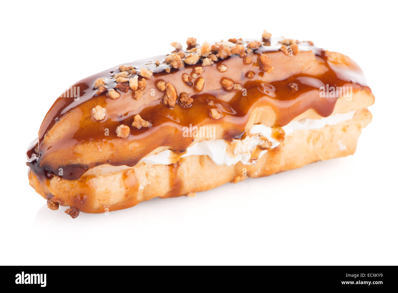 Eclair with caramel decoration on white reflective background Stock ...