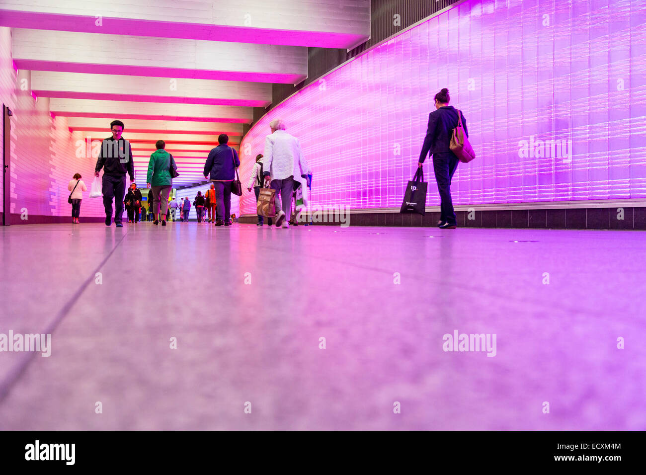 Passengers in an underground passage with a wall of lights Stock Photo ...