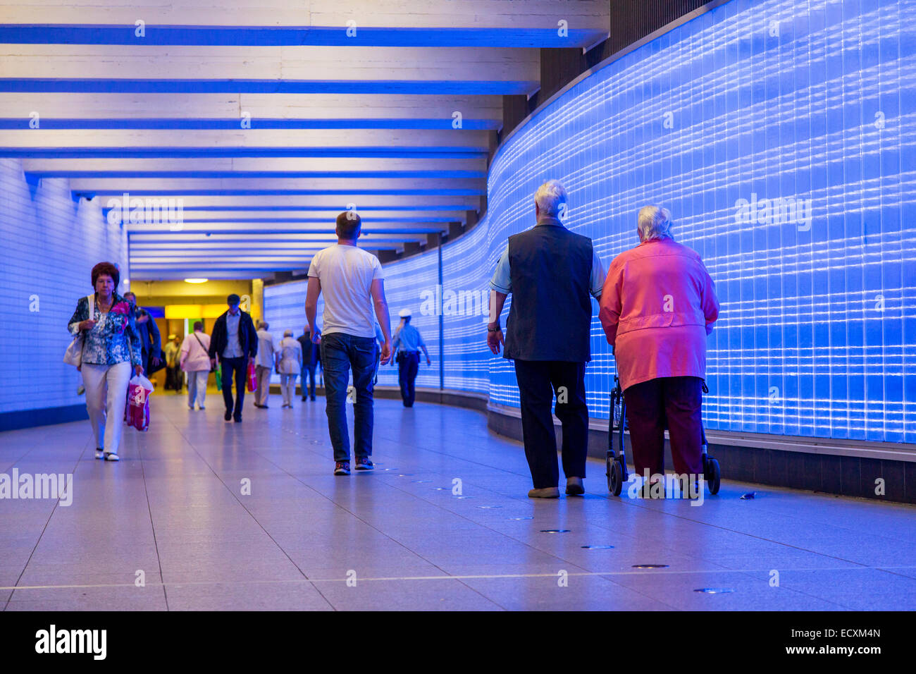 Passengers in an underground passage with a wall of lights Stock Photo ...