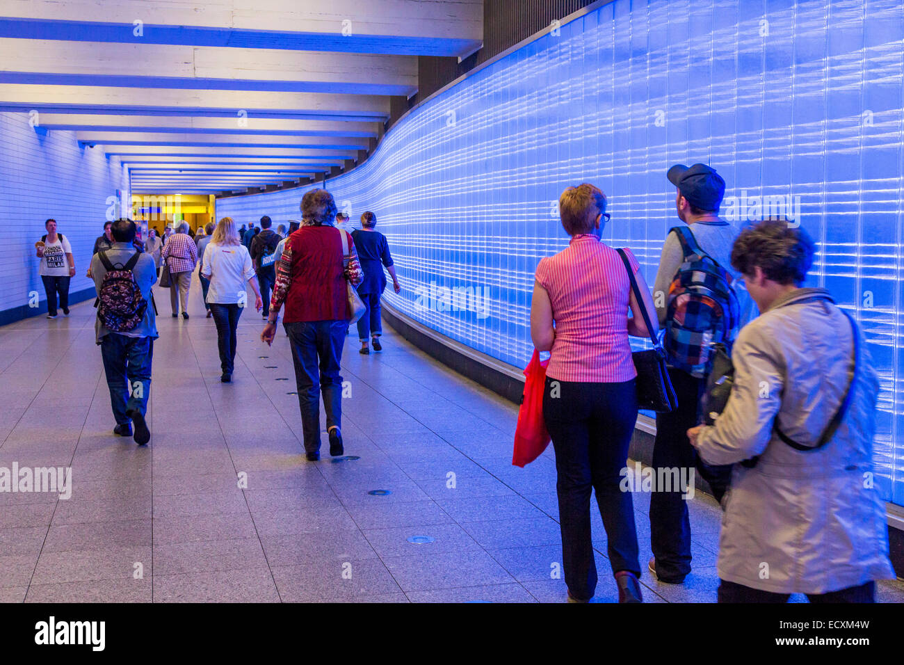 Passengers in an underground passage with a wall of lights Stock Photo ...