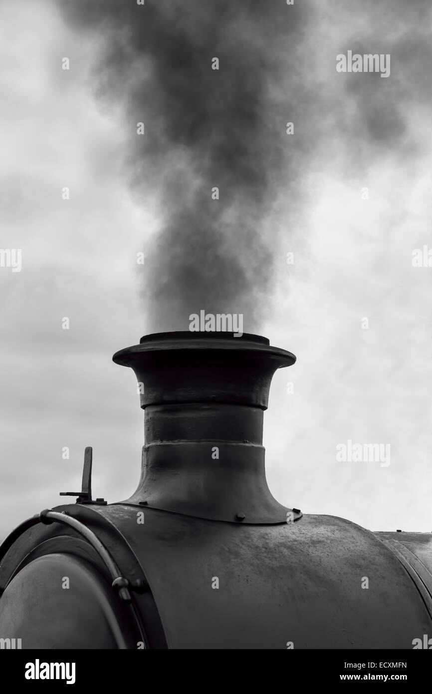 Close upright mono photograph of a single isolated chimney of a steam ...