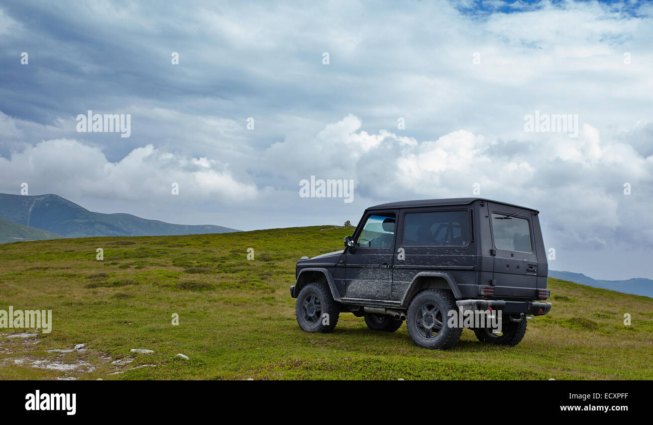 Off road car in a mountain environment on a meadow Stock Photo - Alamy
