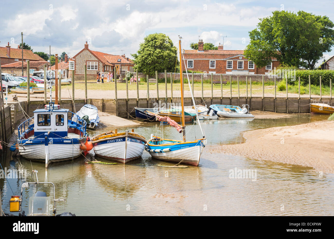 Boats moored in creek in harbour in Blakeney, coastal north Norfolk, UK ...