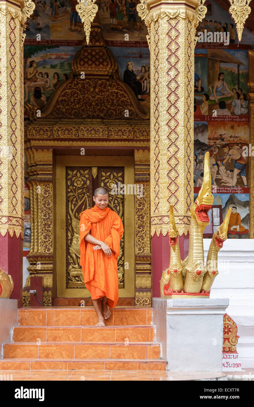 Young Buddhist Monk Walking And Smiling To The Camera. Looking Down ...