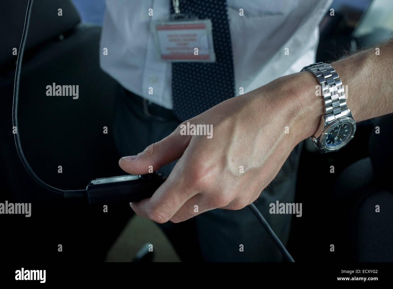 Detail of NATS air traffic controller's hand and radio trigger in ...