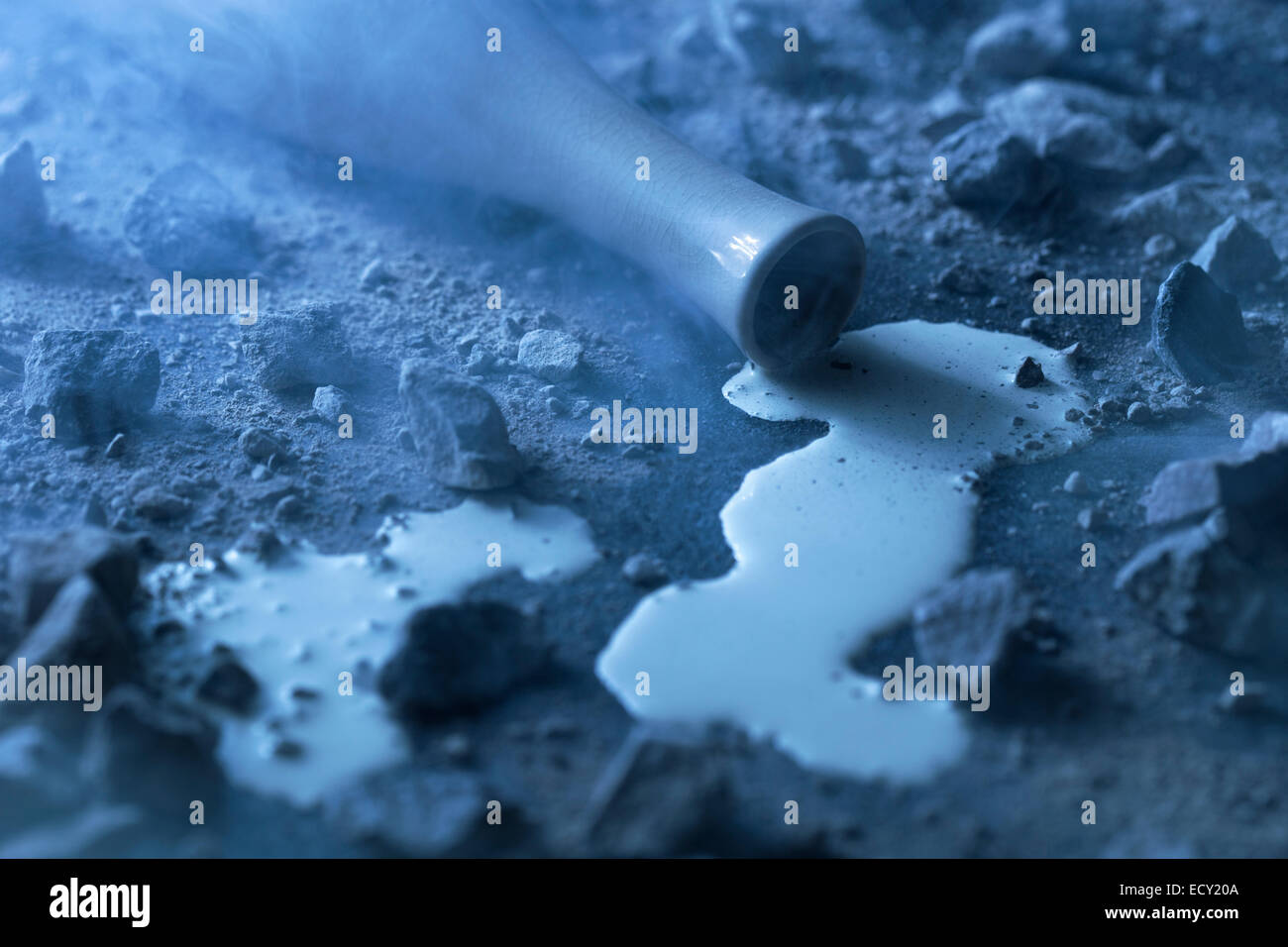 Upset bottle spilling white liquid Stock Photo - Alamy