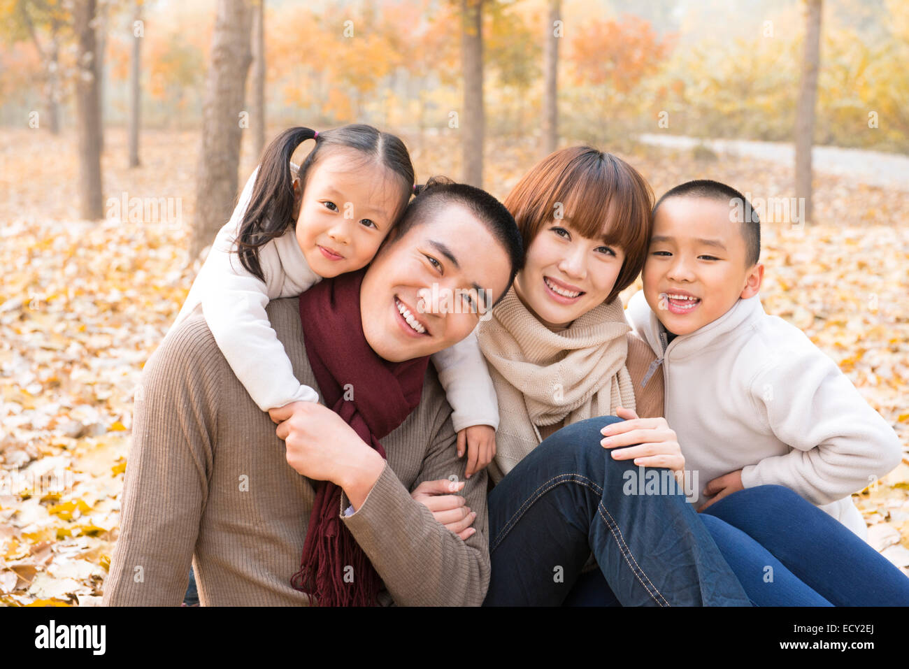 Family with two children at park Stock Photo - Alamy