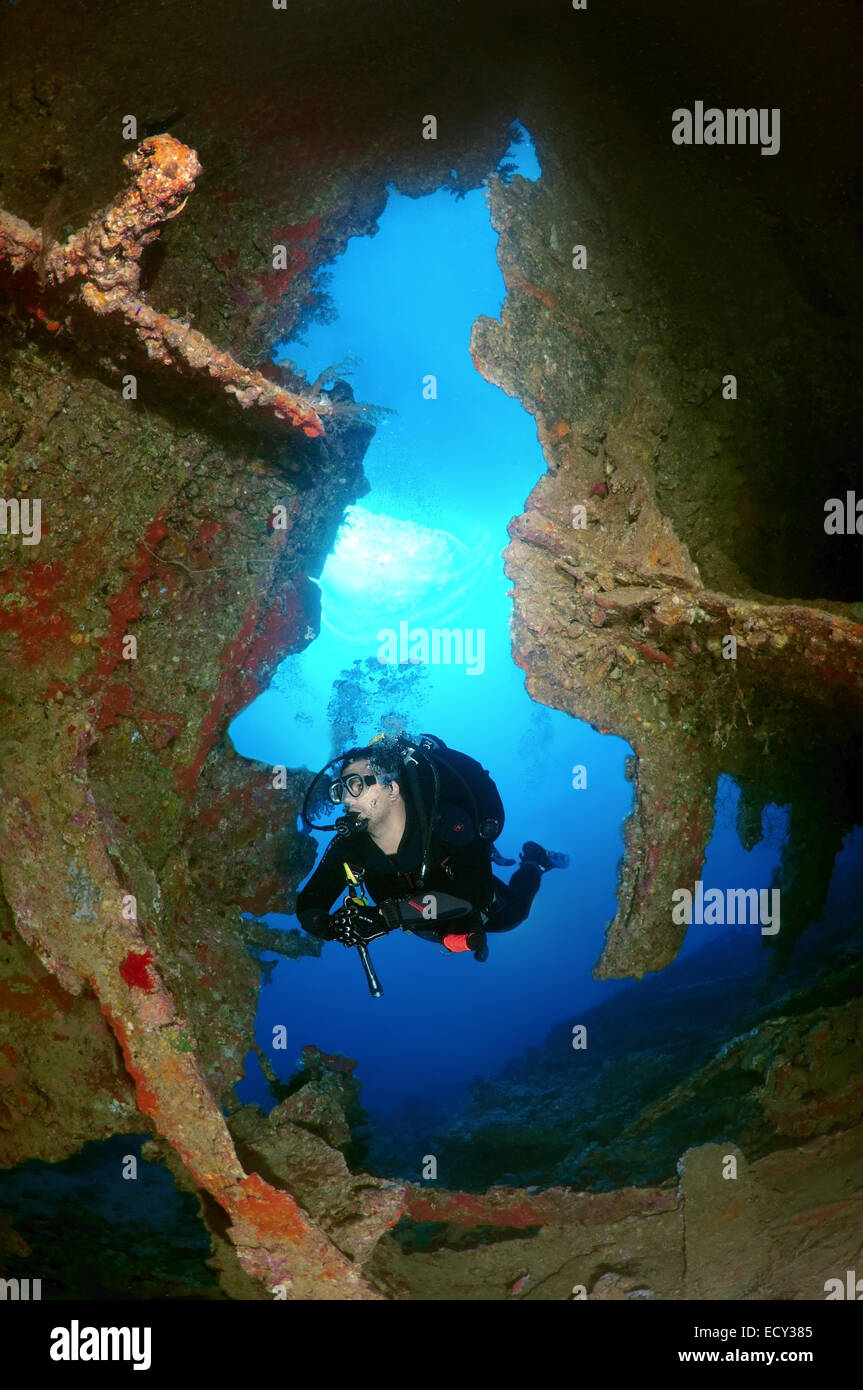 Diver on underwater scooter swims in the hold of the shipwreck "SS ...