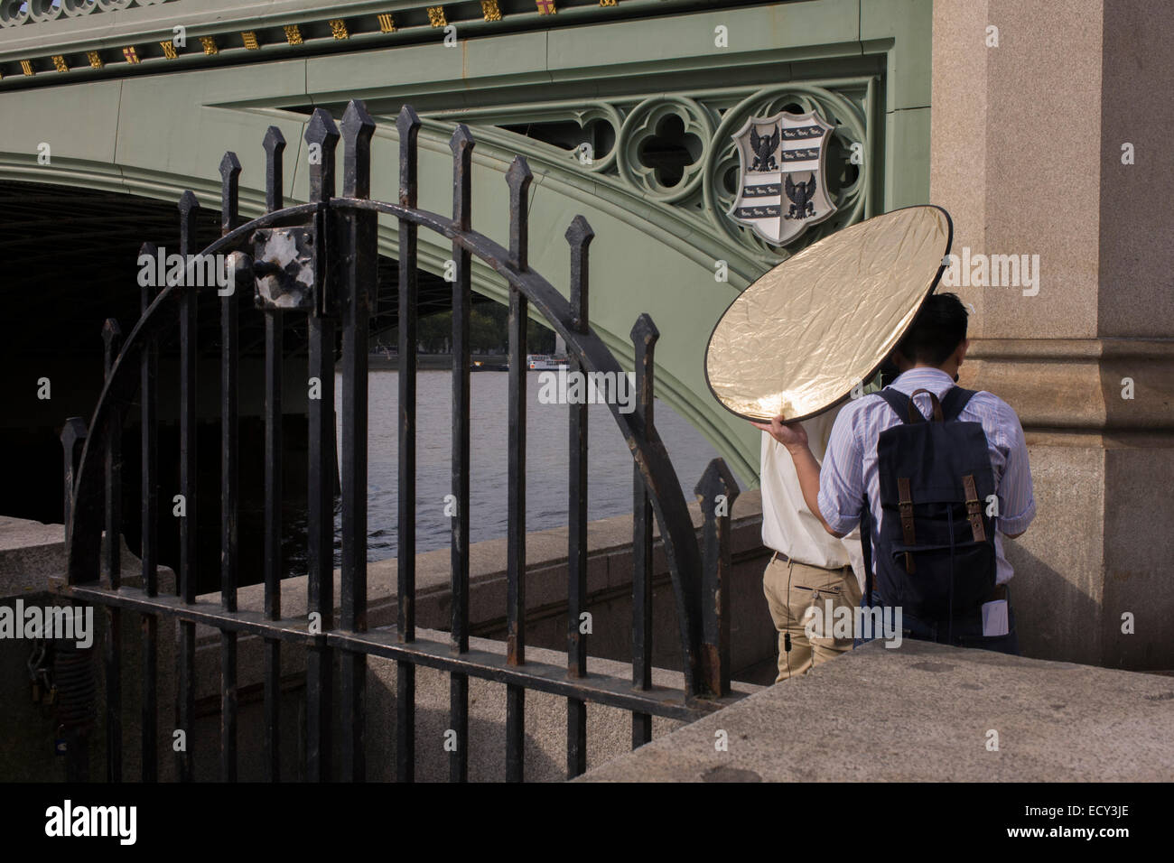 Production team shade themselves under light reflector, a visual ...