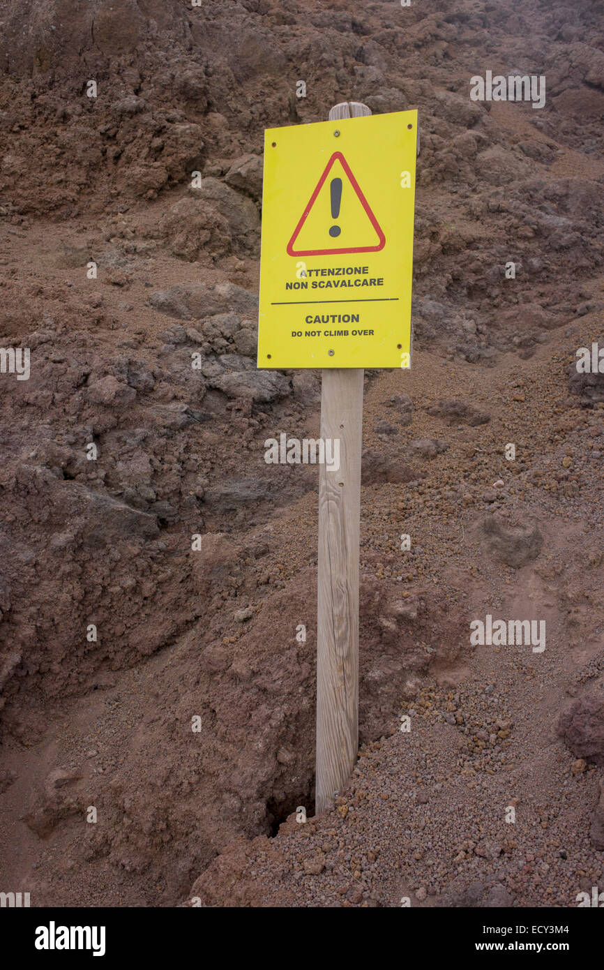 Tourists' warning sign embedded in lava rock at the dormant crater edge ...