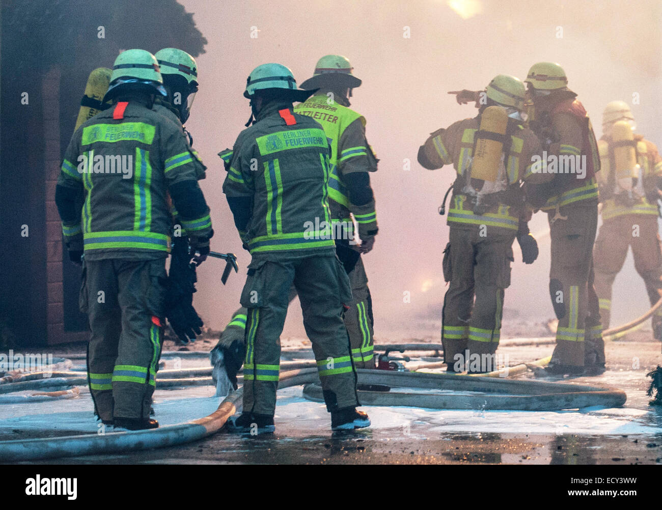 Berlin, Germany. 22nd Dec, 2014. Firefighters extinguish a fire at the ...