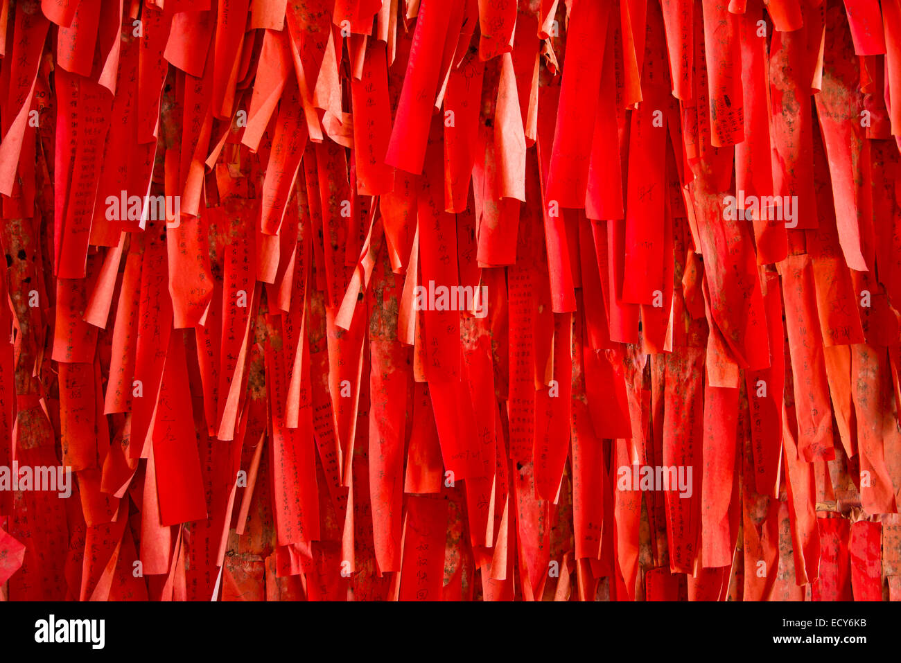 Red luck or wishing papers on a wall in the temple, Ciqikou, Chongqing ...
