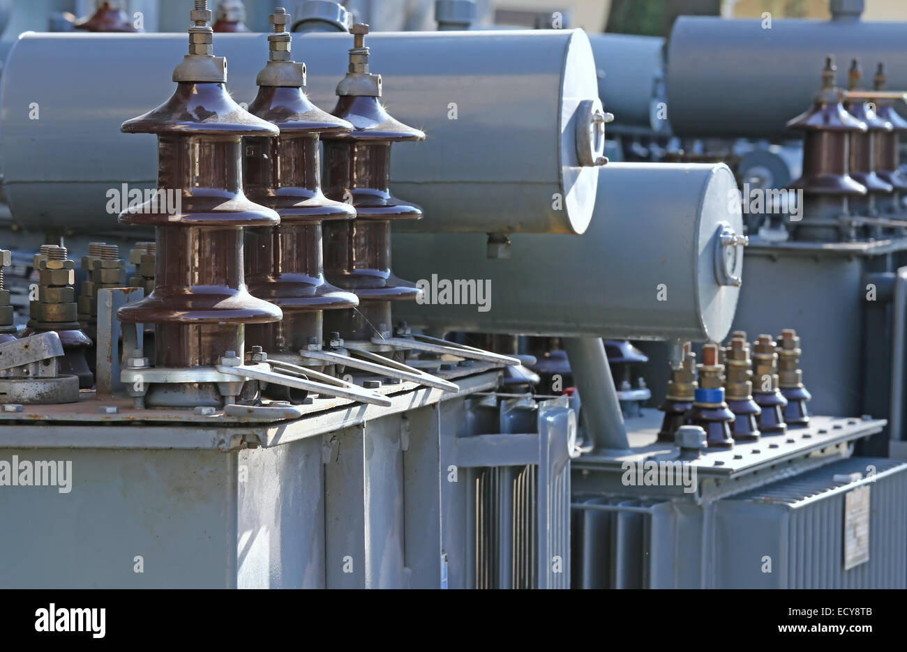 piles of old voltage transformers in a landfill of electrical equipment ...