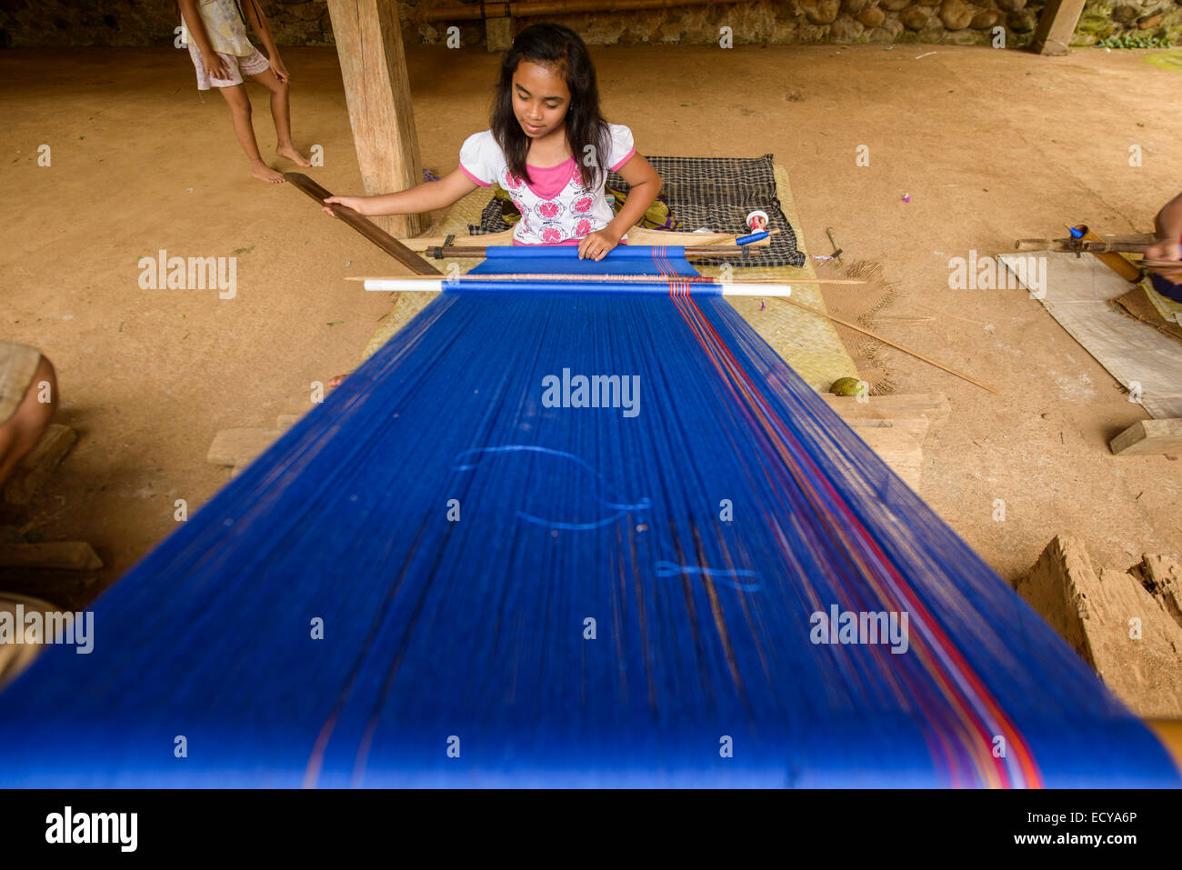 Girl weaving textiles, Sulawesi, Indonesia Stock Photo - Alamy