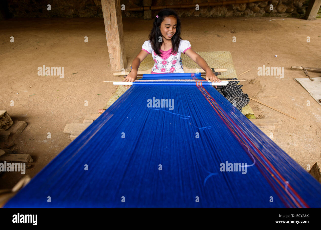 Girl weaving textiles, Sulawesi, Indonesia Stock Photo - Alamy