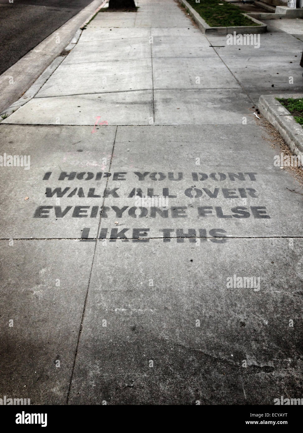 Spray-painted graffiti on city sidewalk Stock Photo - Alamy