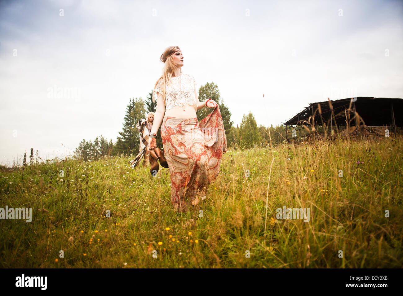 Caucasian woman walking in field Stock Photo - Alamy