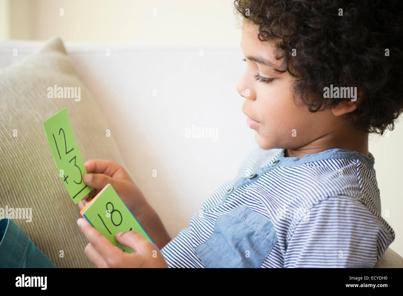 Mixed race boy using flash cards to study math Stock Photo - Alamy