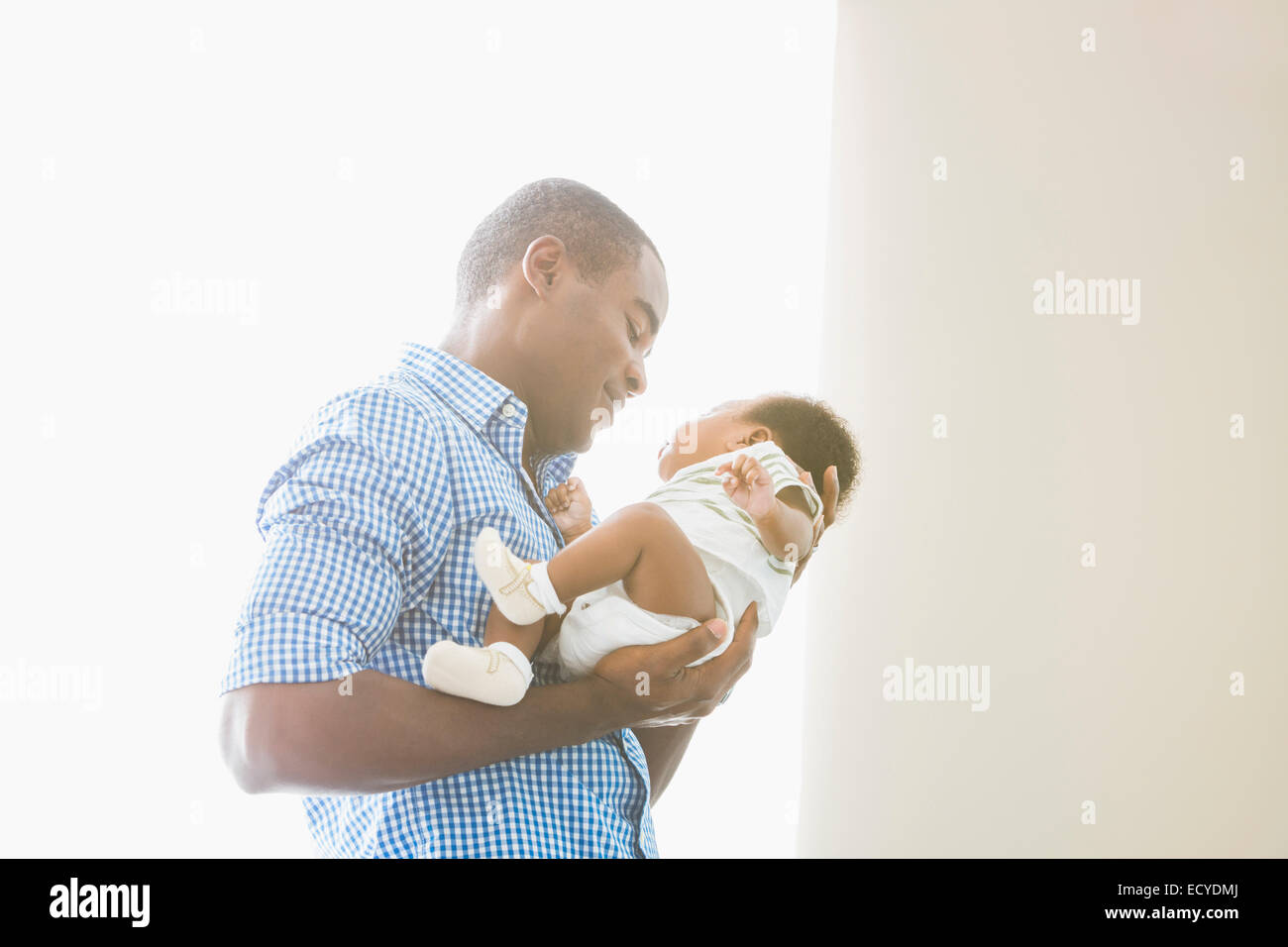 Father cradling baby son Stock Photo - Alamy