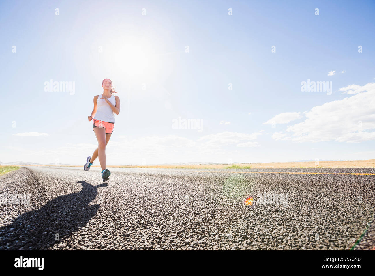 Athletic woman running on road hi-res stock photography and images - Alamy