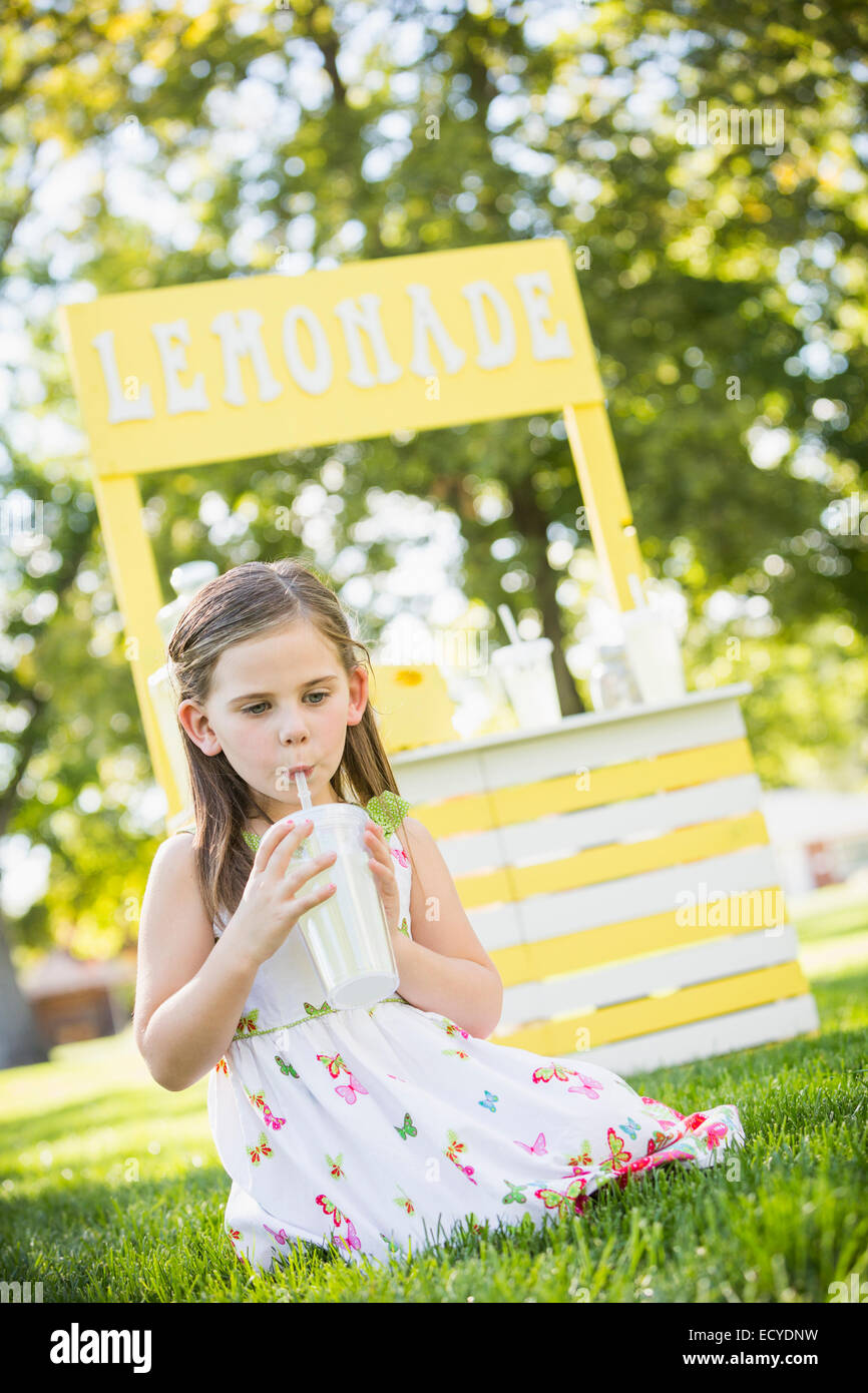Caucasian girl drinking at lemonade stand Stock Photo - Alamy