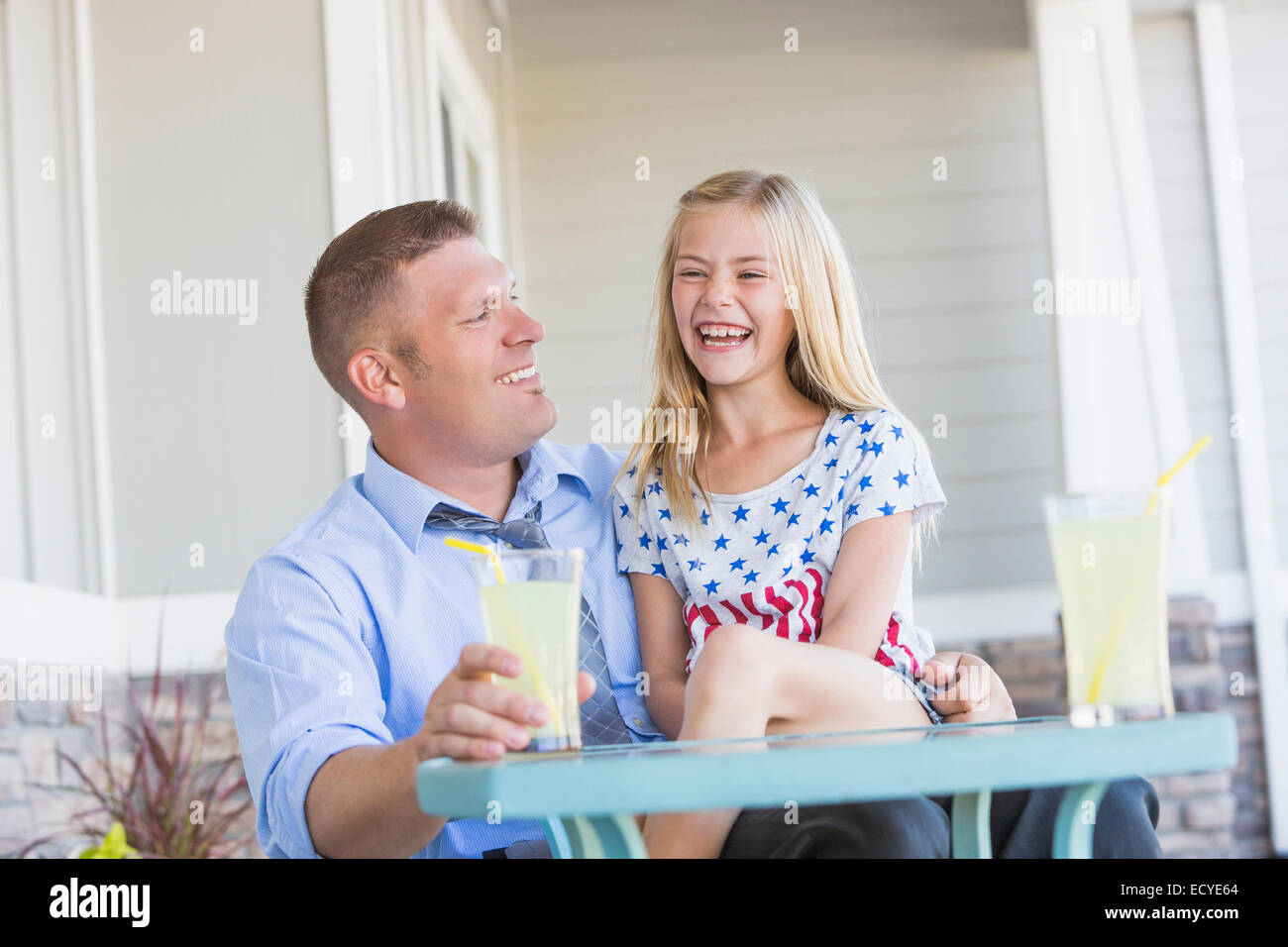 Caucasian father and daughter laughing on porch Stock Photo - Alamy