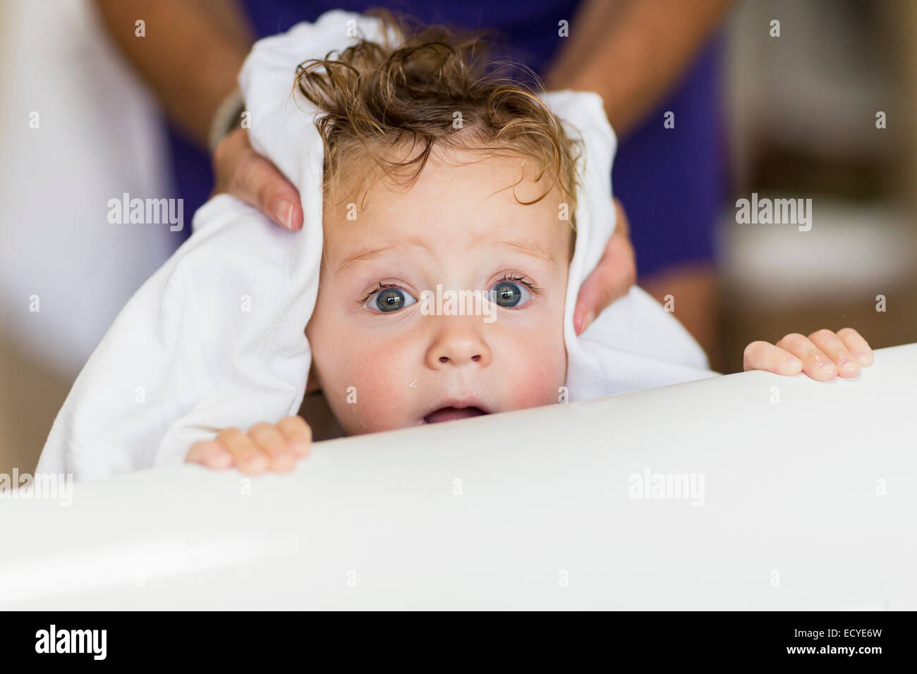 Mother drying hair of baby son Stock Photo - Alamy