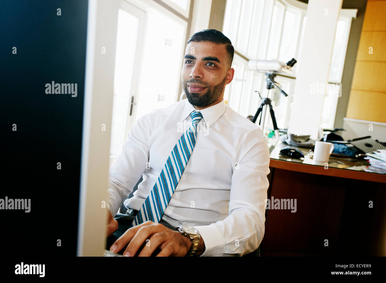 Middle Eastern businessman working at computer in office Stock Photo ...