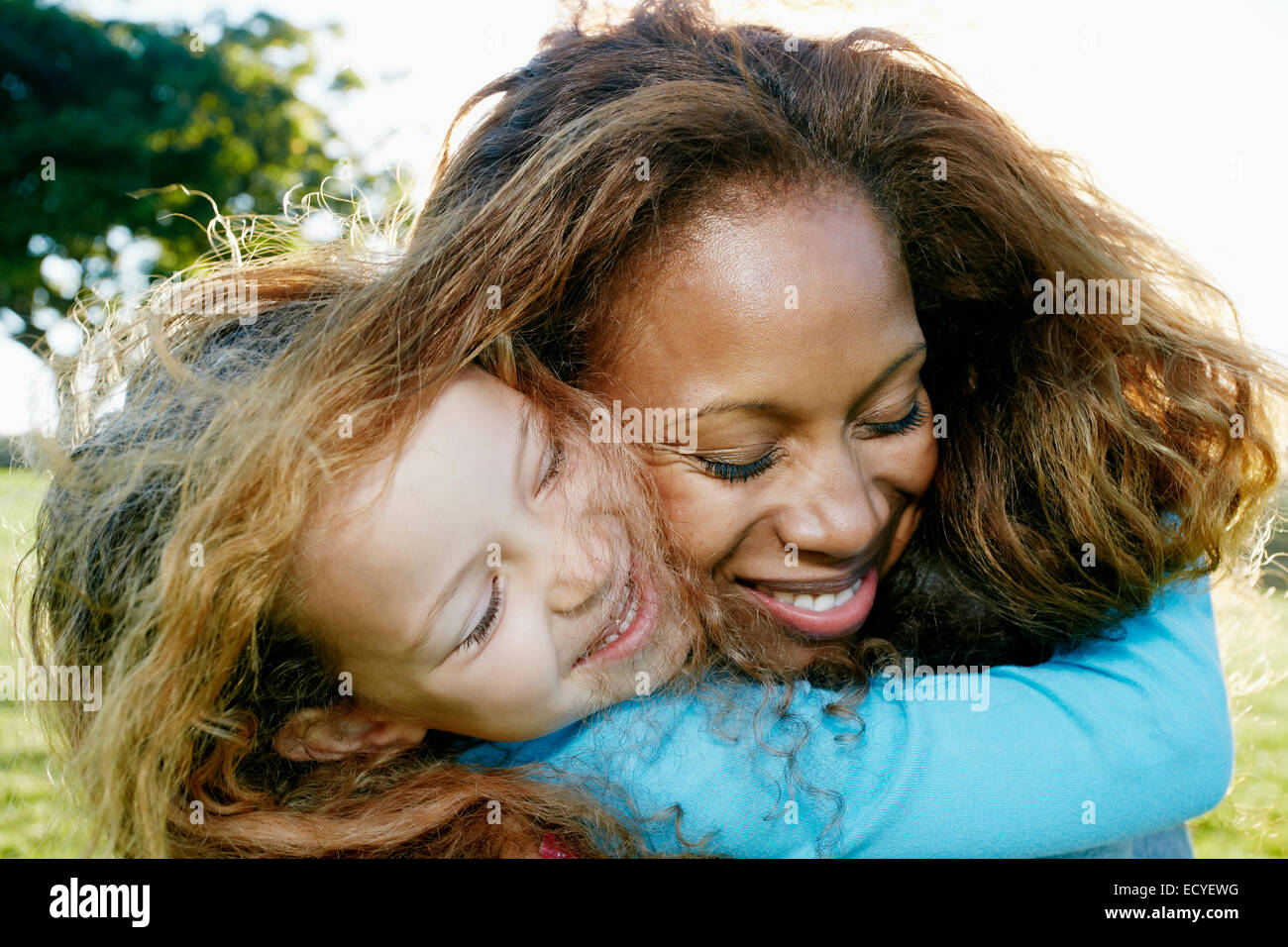 Mother and daughter hugging outdoors Stock Photo - Alamy