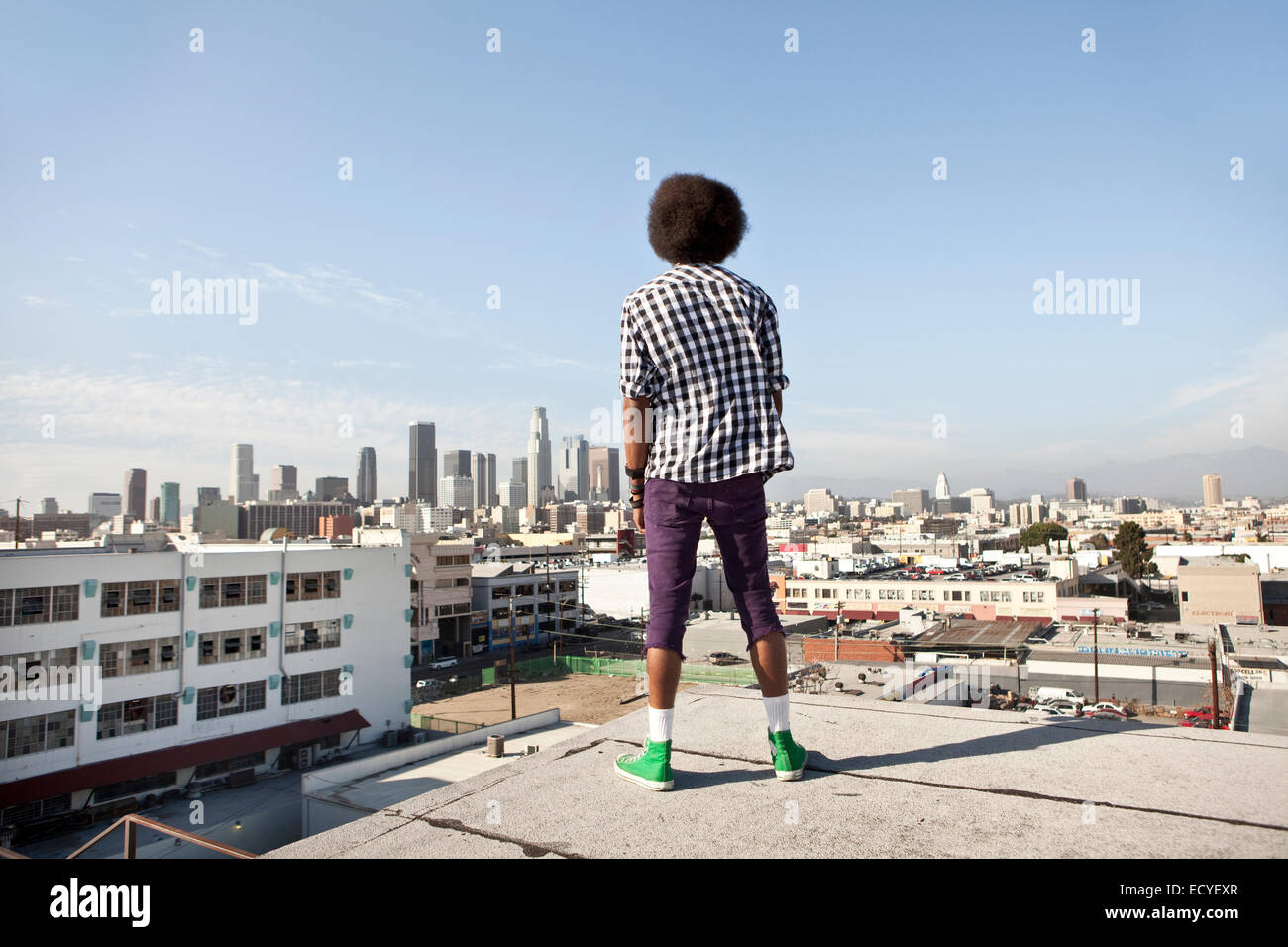 African American man overlooking cityscape from urban rooftop Stock ...