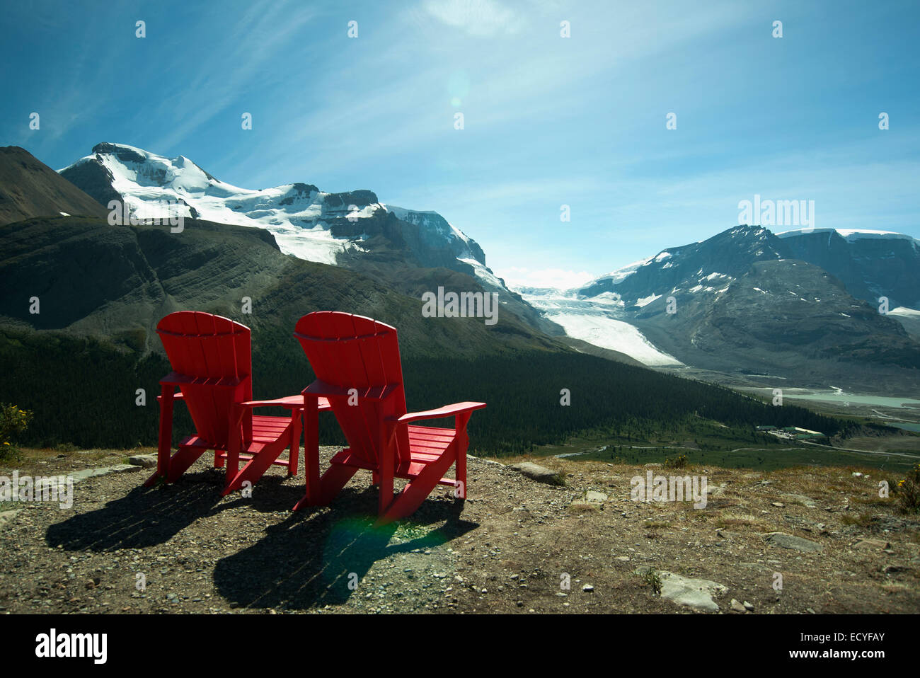 Red lawn chairs overlooking scenic mountain landscape Stock Photo - Alamy