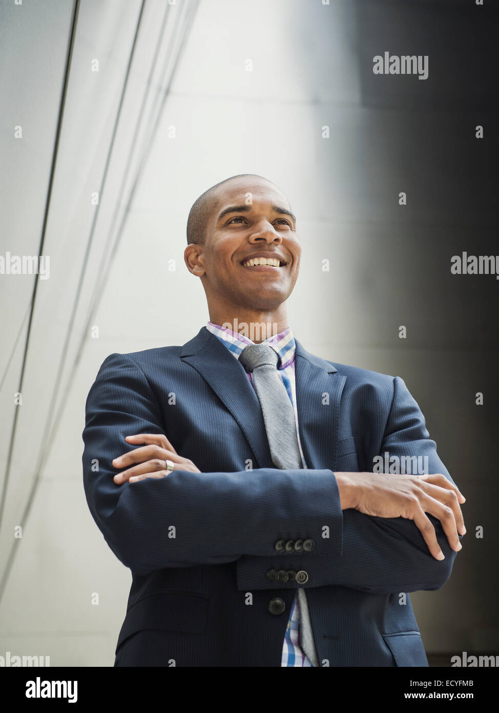 Businessman standing with his arms crossed Stock Photo - Alamy