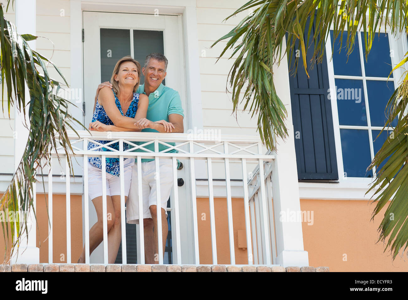 Caucasian couple standing on balcony Stock Photo - Alamy