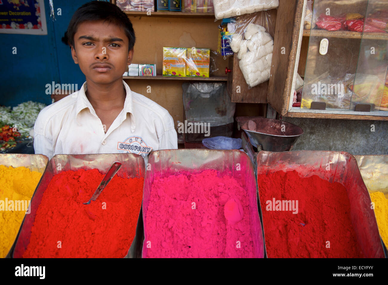 MYSORE, INDIA - NOVEMBER 4, 2012: Young Indian vendor stands behind ...